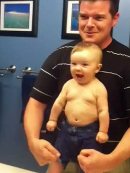 Too cute: Baby shows off his muscles with dad | 13newsnow.com