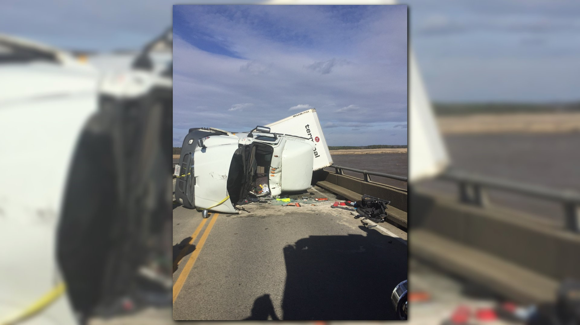 Tractor-trailer blown over on bridge hits SUV | 13newsnow.com